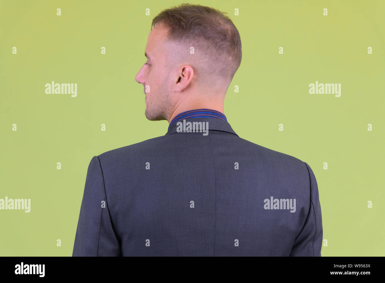 Closeup rear view of businessman in suit looking over shoulder Stock ...