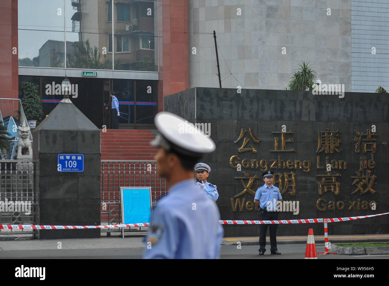 Chinese police officers stand guard outside the Chengdu Intermediate ...