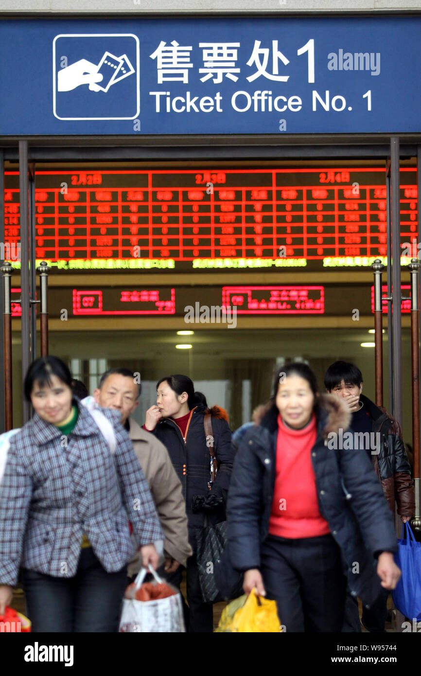 Chinese passengers walk out from a ticket office at the Hankou Railway ...