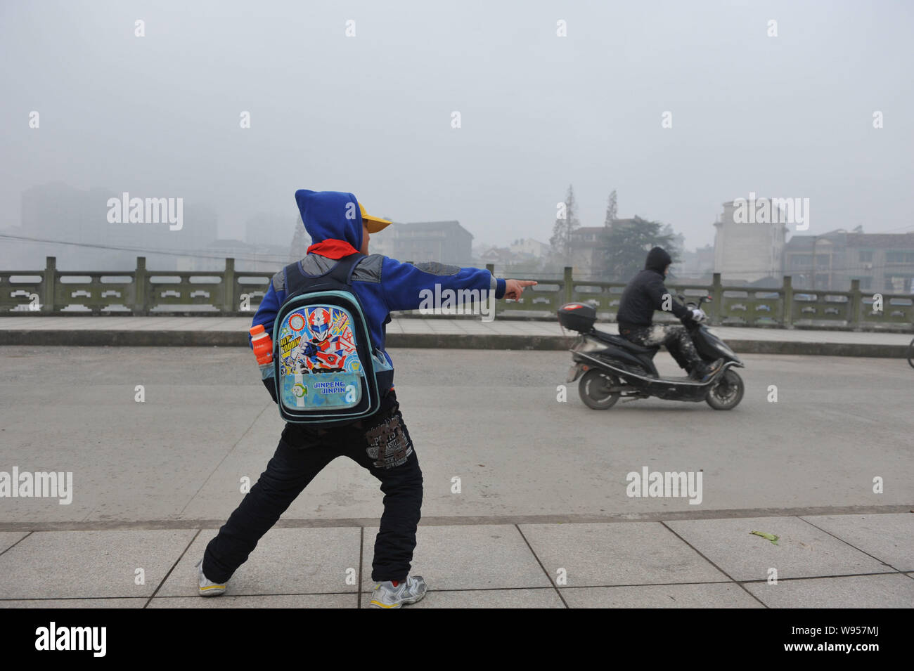 A young Chinese student mimics the hand signals of flight deck crew ...