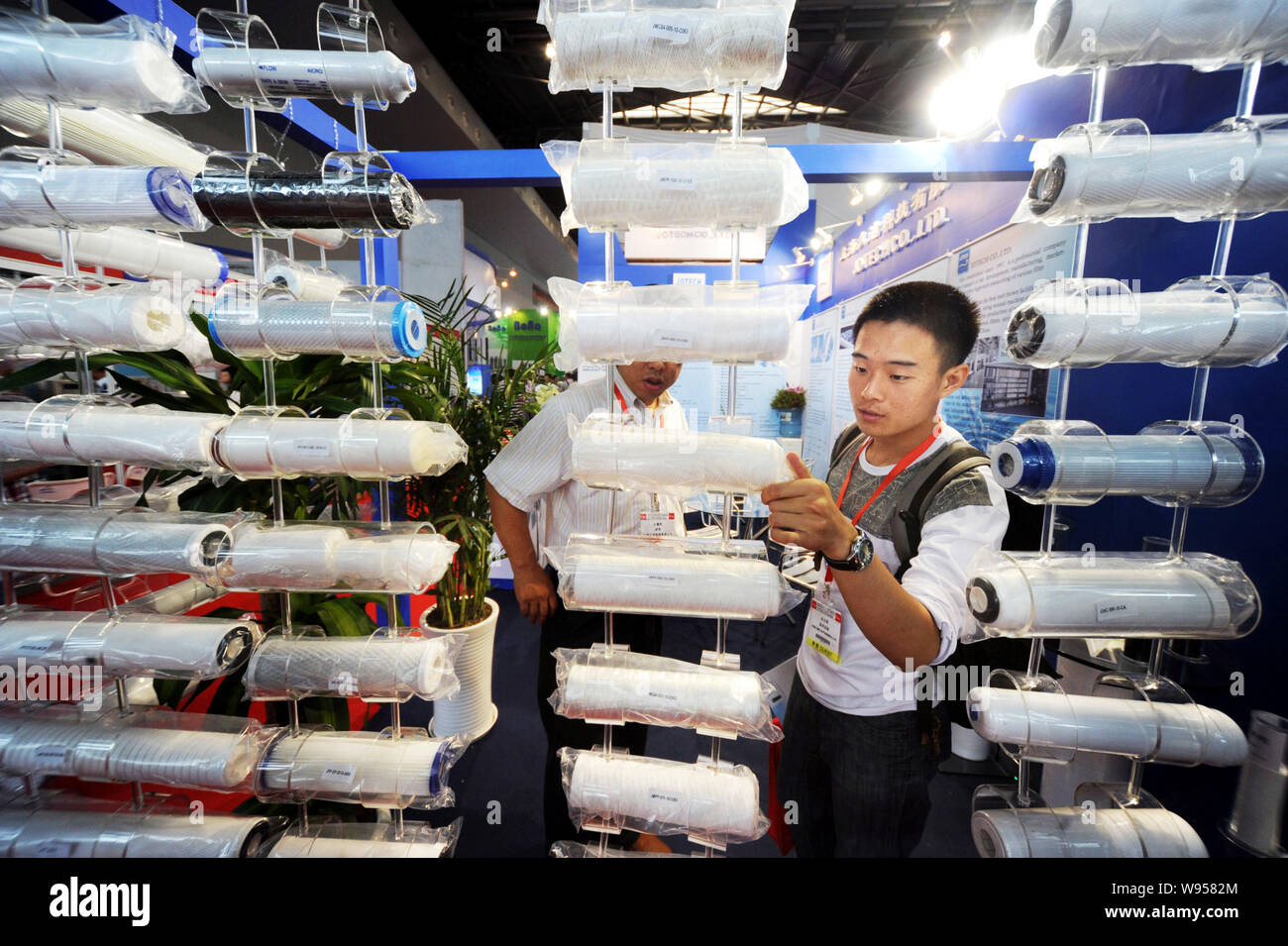 Visitors look at filters of water purifiers during the Fifth Shanghai ...