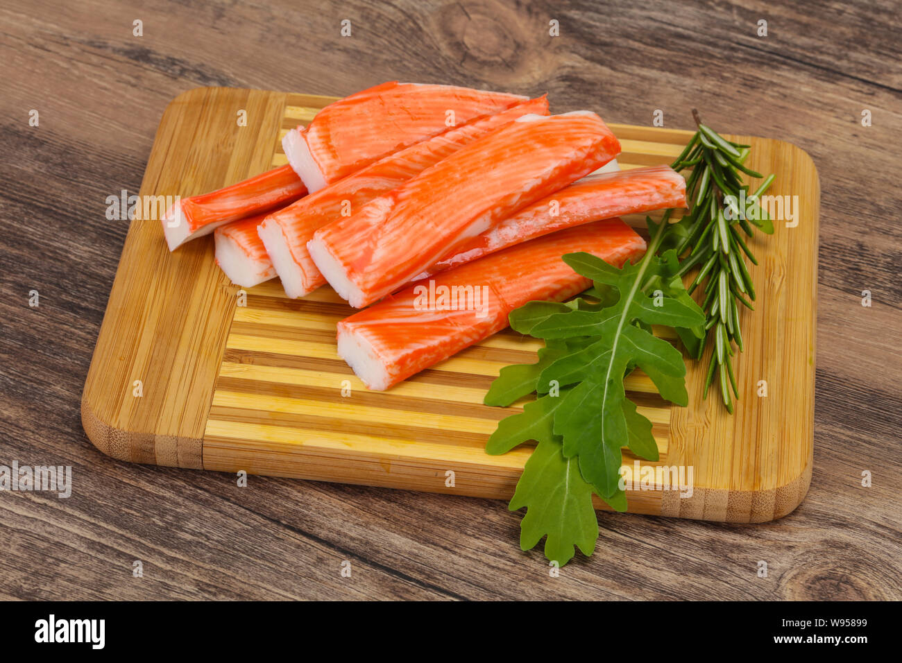 Crab stick surimi over wooden board Stock Photo - Alamy