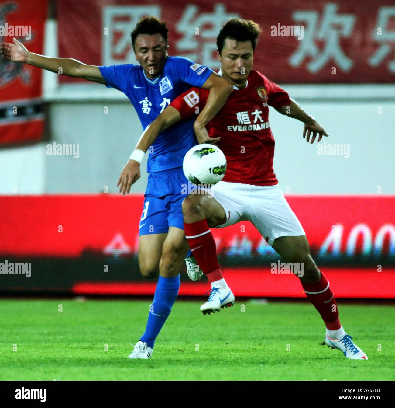 Liu Cheng of Guangzhou R&F FC, left, challenges Gao Lin of Guangzhou ...