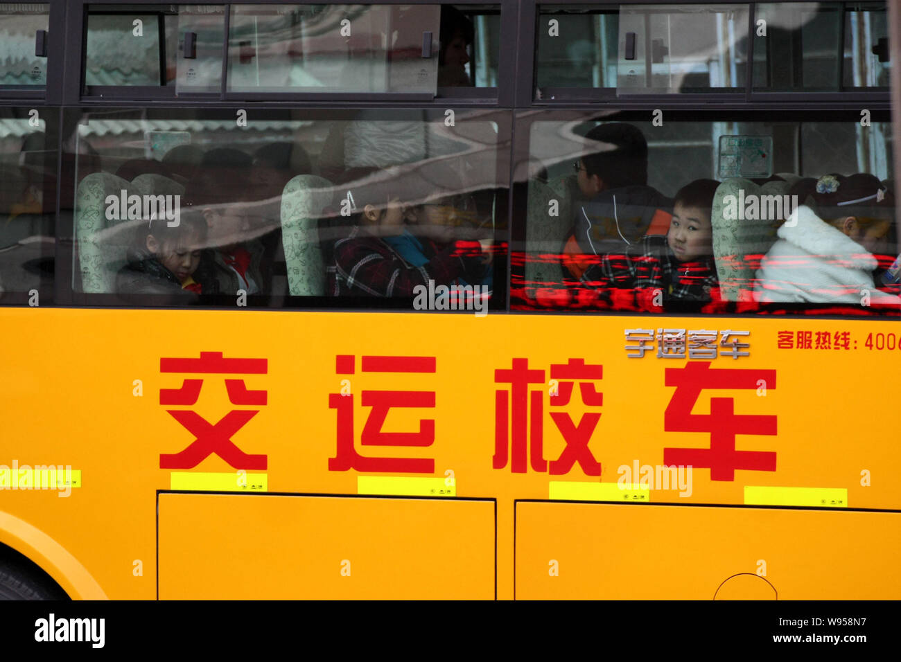 --FILE--Young Chinese students sit in a school bus in Qingdao city ...