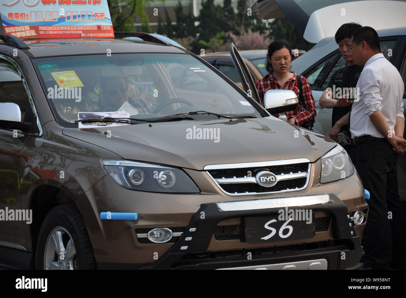 --FILE--Visitors look at a BYD S6 SUV during an auto show in Qingdao city, east Chinas Shandong ...