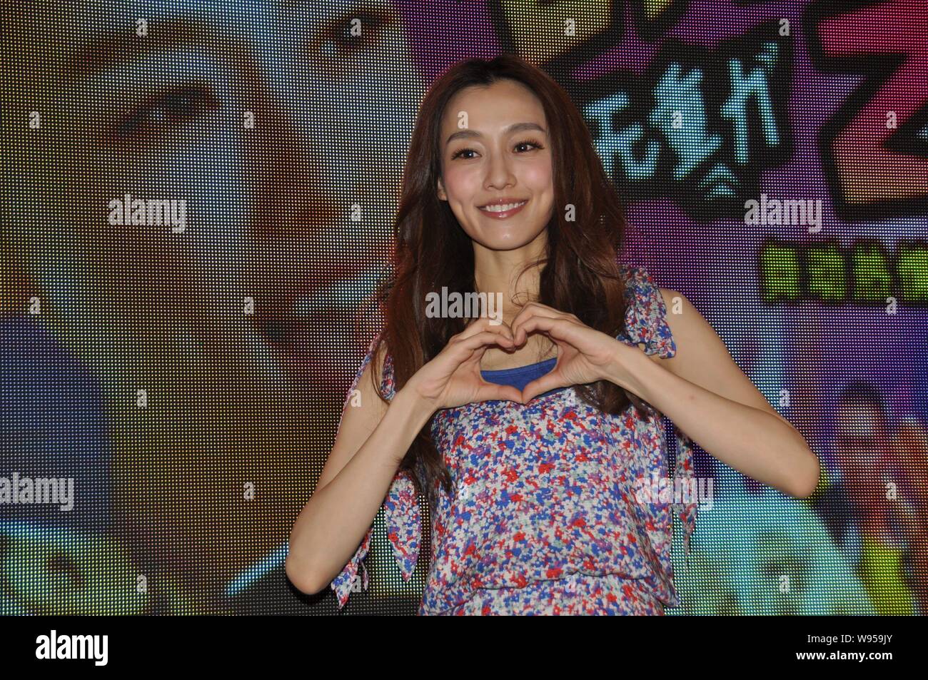 Taiwanese singer and actress Fan Fan poses with heart gesture during ...