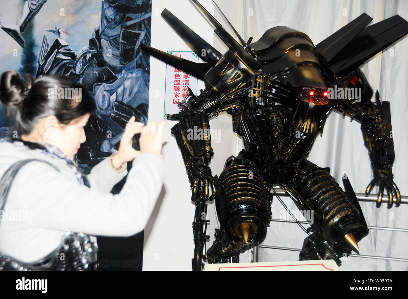 A visitor takes photos of a model of Jetfire, a robot figure in the ...