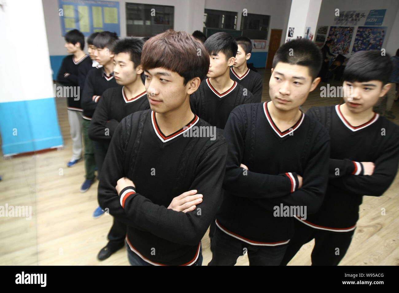 Male high school students dressed black sweaters pose in a model ...