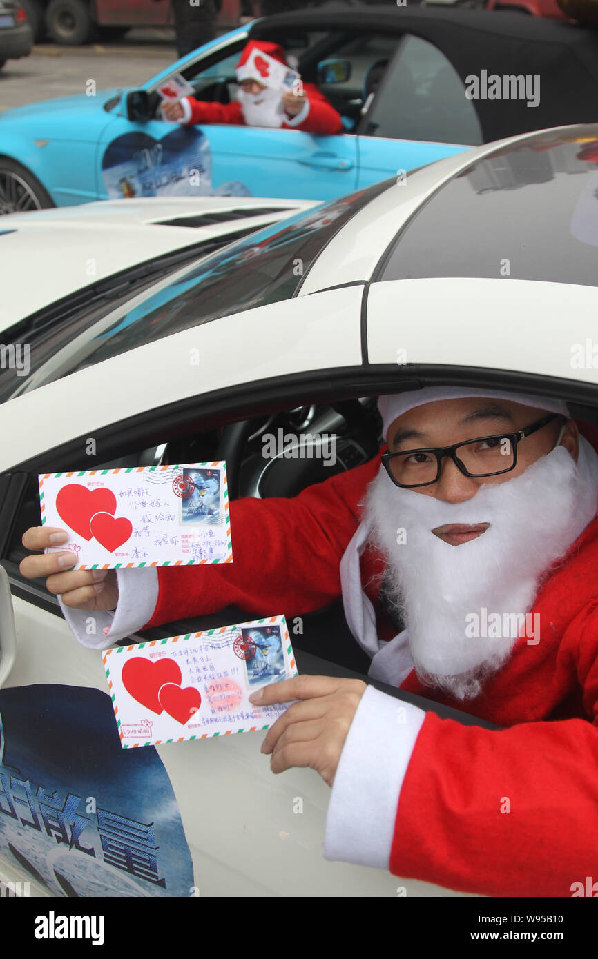 Young Chinese men dressed in Santa Claus costumes drive their cars to ...