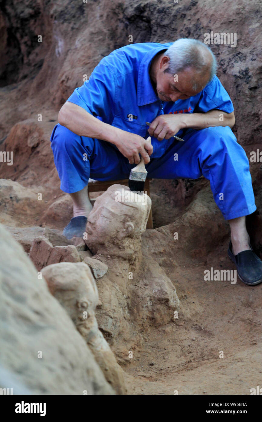 A Chinese archaeologist excavates a terracotta warrior in the No.1 Pit ...