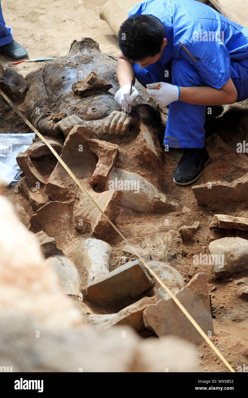 A Chinese archaeologist excavates a terracotta warrior in the No.1 Pit ...