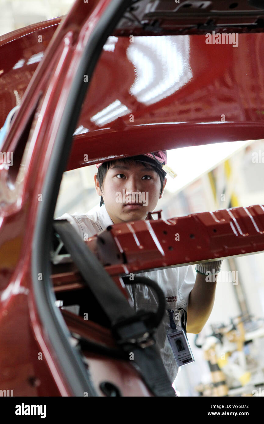A Chinese worker assembles a Fiat Viaggio car on the assembly line at ...