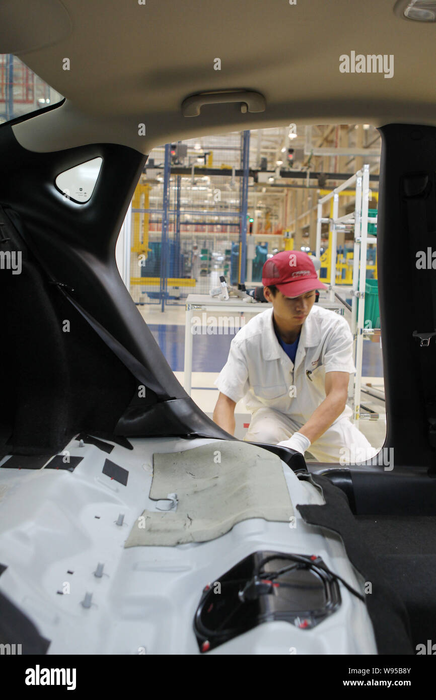 A Chinese worker assembles a Fiat Viaggio car on the assembly line at ...
