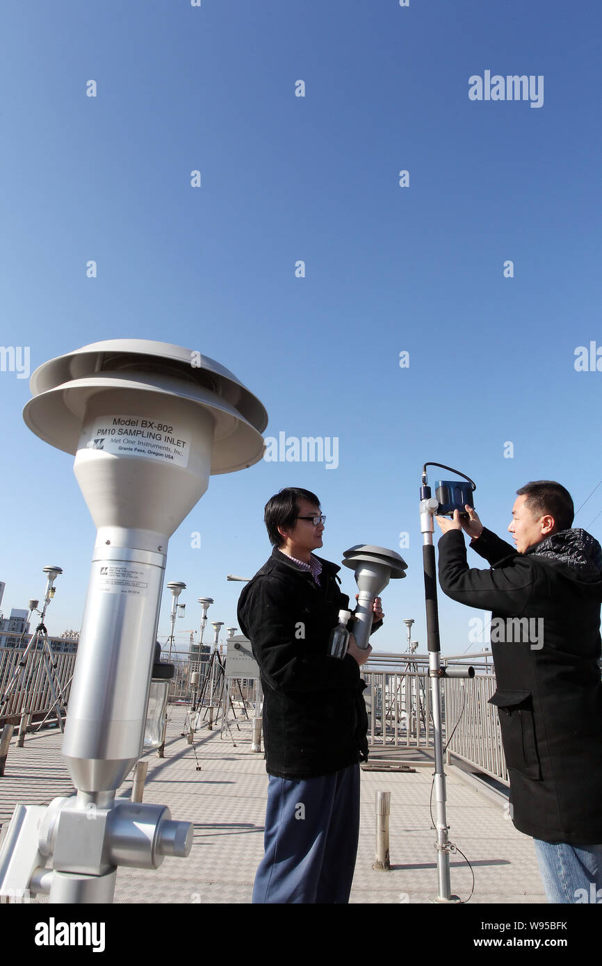 Chinese environmental monitoring workers install device to detect PM2.5 ...