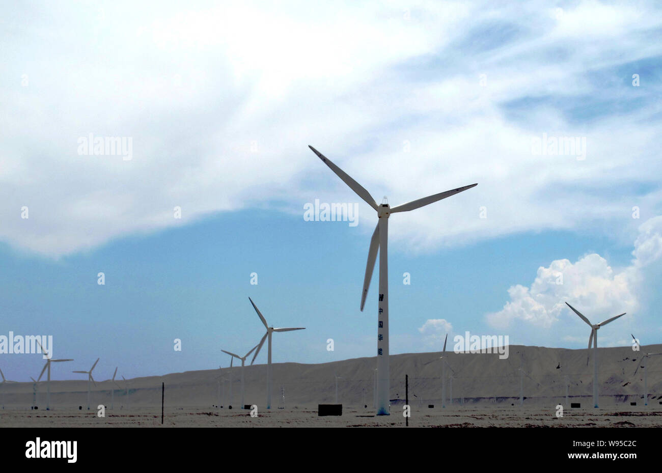 --FILE--Wind turbines whirl to generate electricity at a wind farm in ...