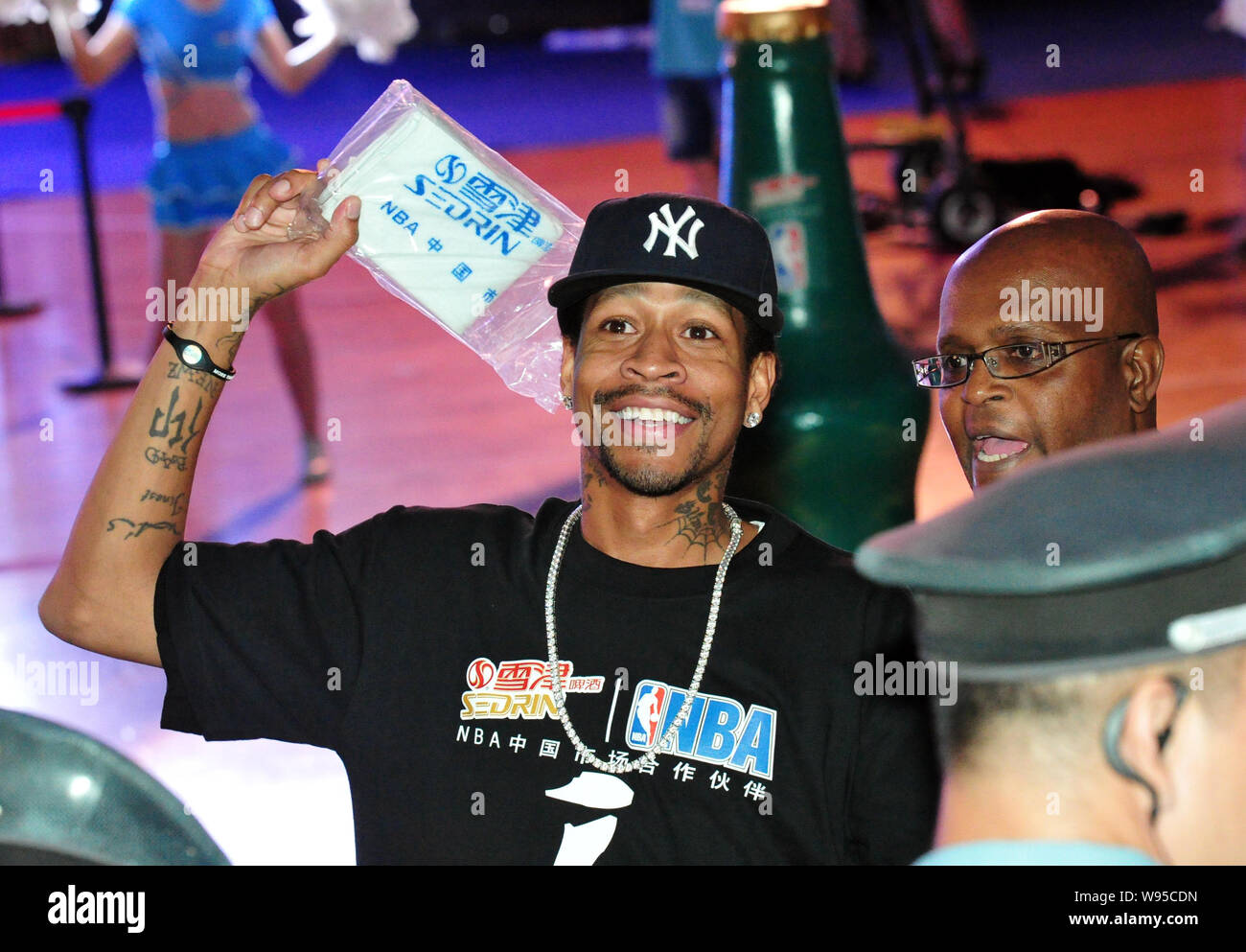 NBA superstar Allen Iverson, left, throws a gift to fans at a ...