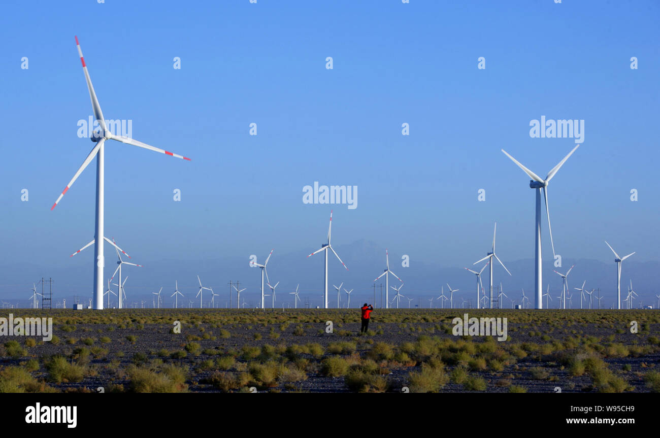 --FILE--Wind turbines whirl to generate electricity at a wind farm in ...