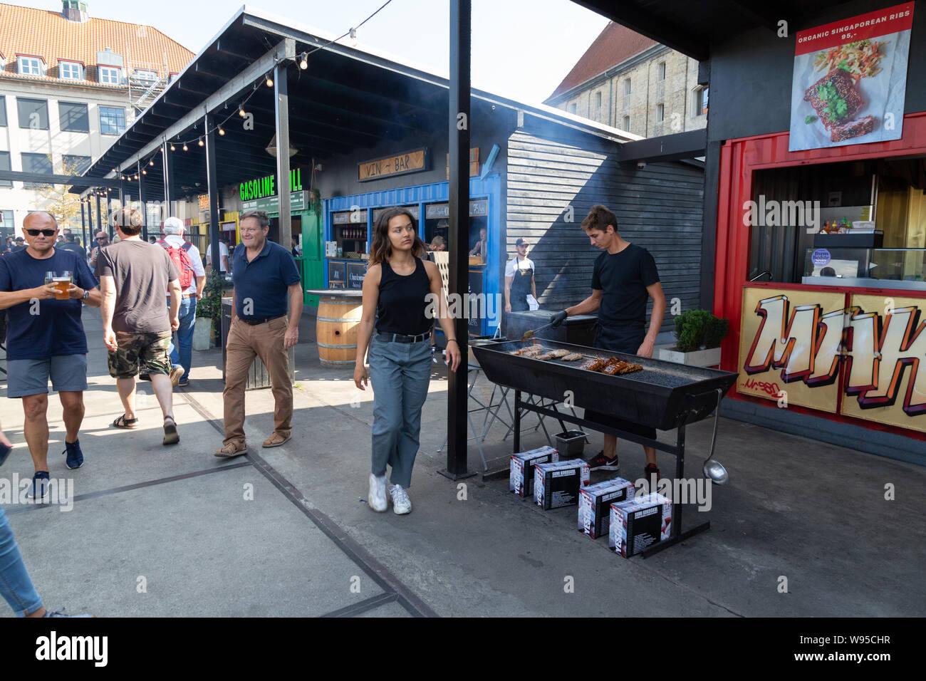People at a Copenhagen street food market, with street barbecue ...