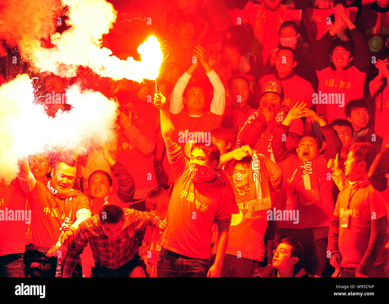 Chinese soccer fans launch fireworks to celebrate during a friendly ...
