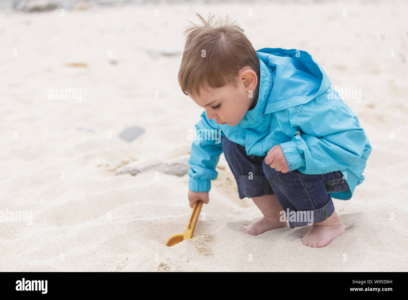 Boy digging sand hi-res stock photography and images - Alamy
