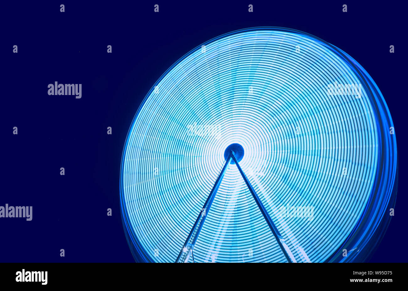 One blue ferris wheel at night and blue sky background Stock Photo - Alamy