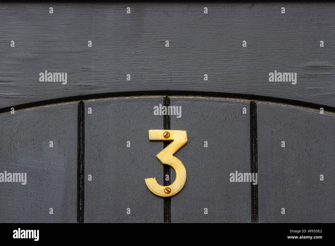 House number three with the 3 in golden brass Stock Photo - Alamy