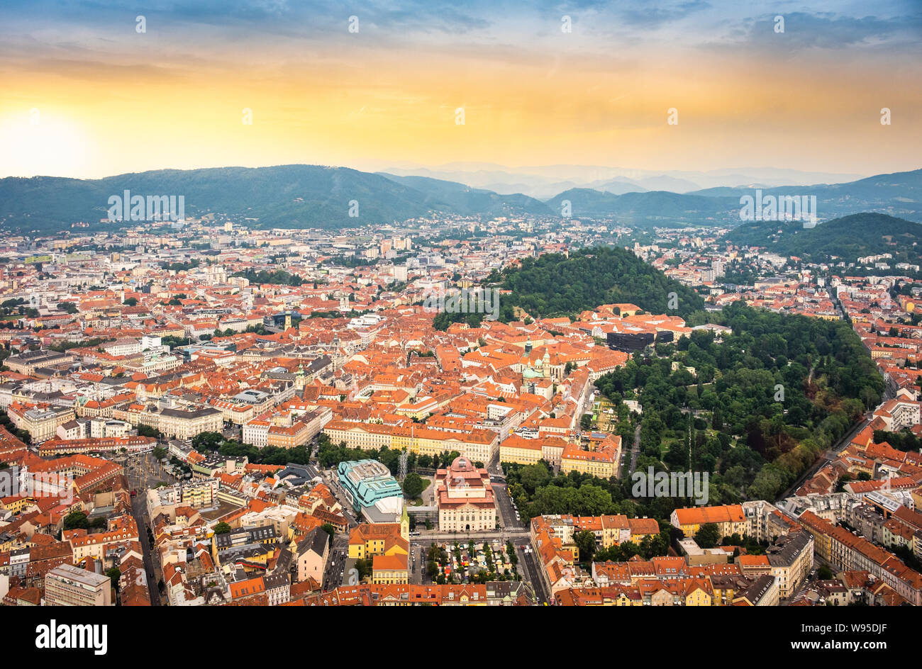Aerial view of center city Graz from helicopter drone with hill ...