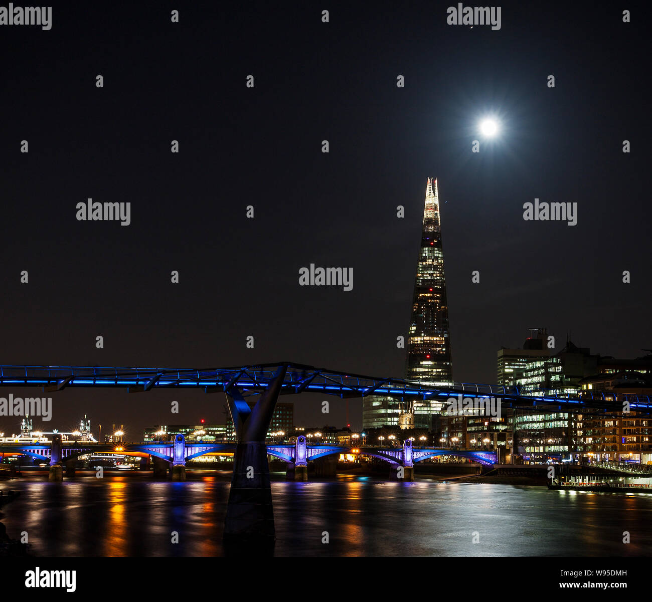 night view of the Millenium Bridge from Waterloo Bridge with the Shard ...