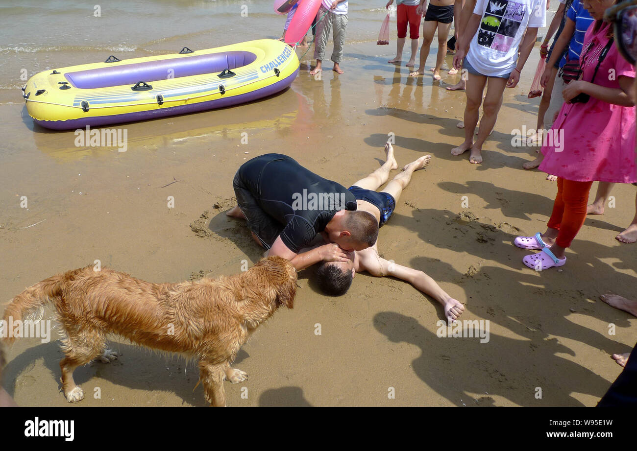 An Australian is seen performing mouth-to-mouth respiration for a ...