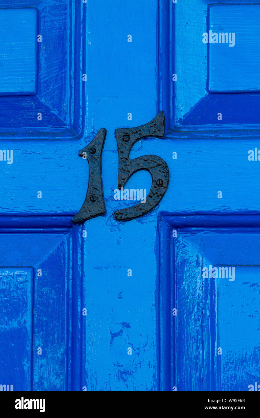 House number 15 on a bright blue wooden front door Stock Photo - Alamy