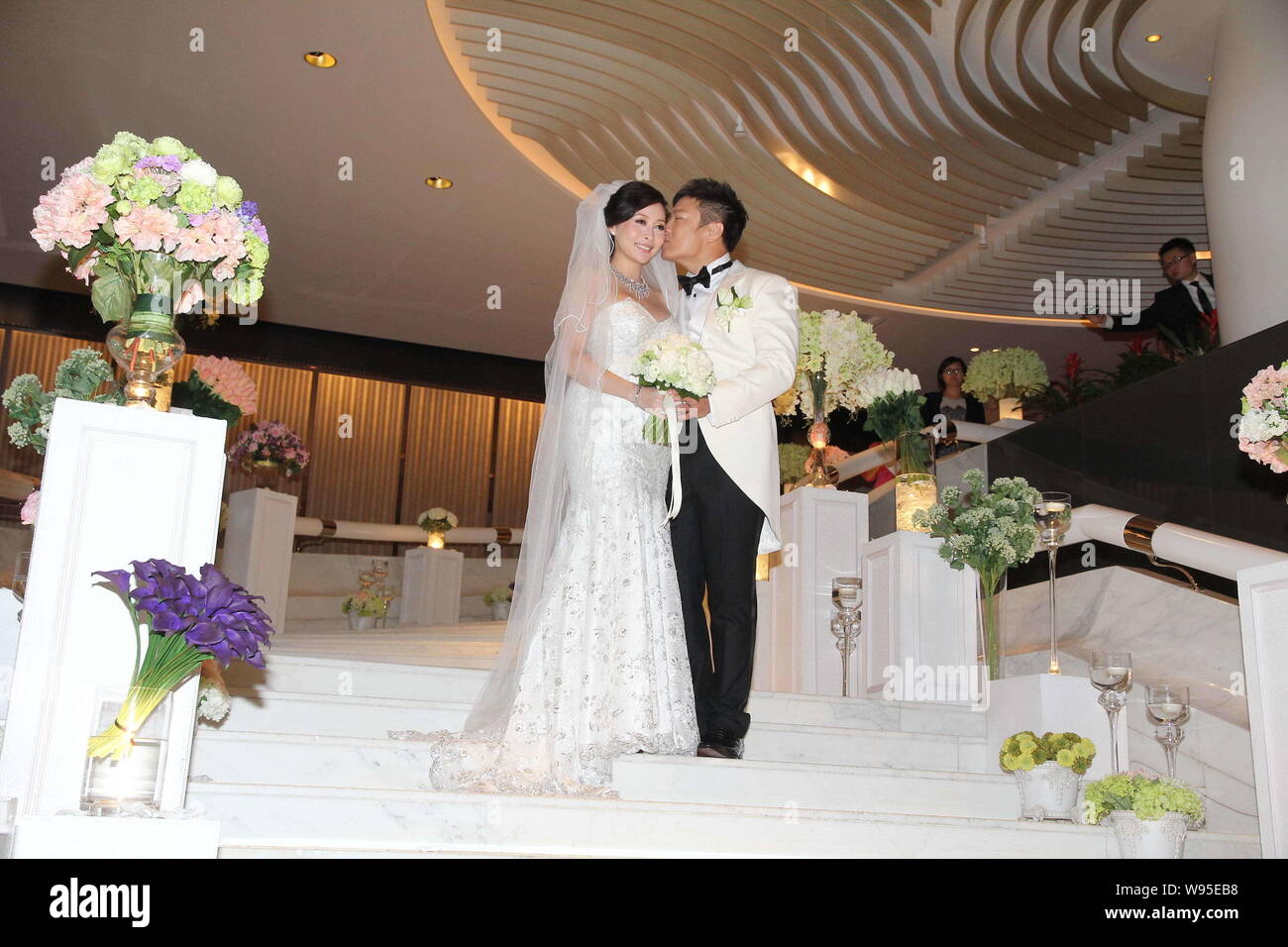 Hong Kong actor Chin Ka Lok, right, kisses his pregnant actress wife ...