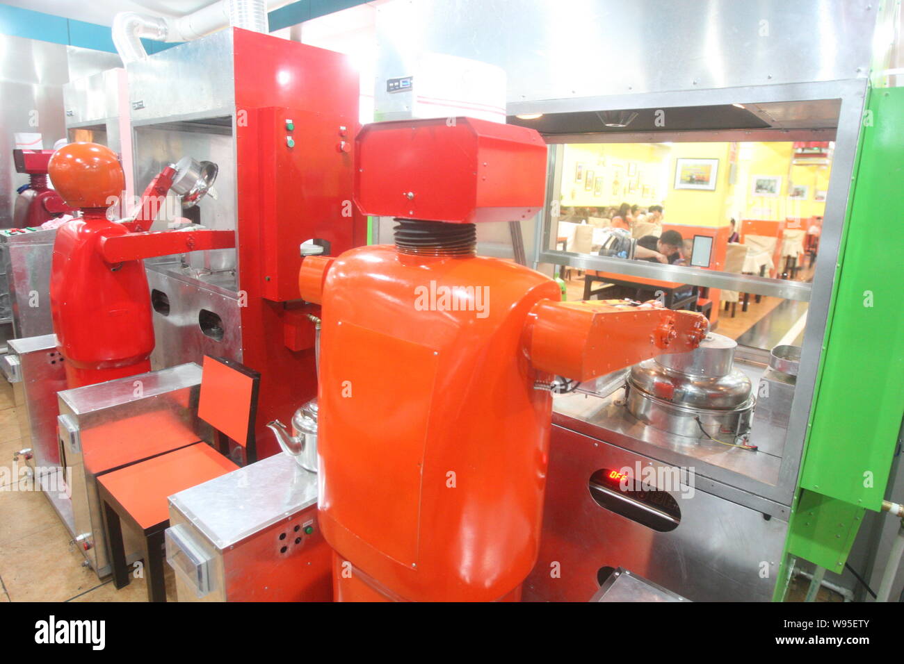 Robots are seen cooking at the Robot Restaurant in Harbin city ...