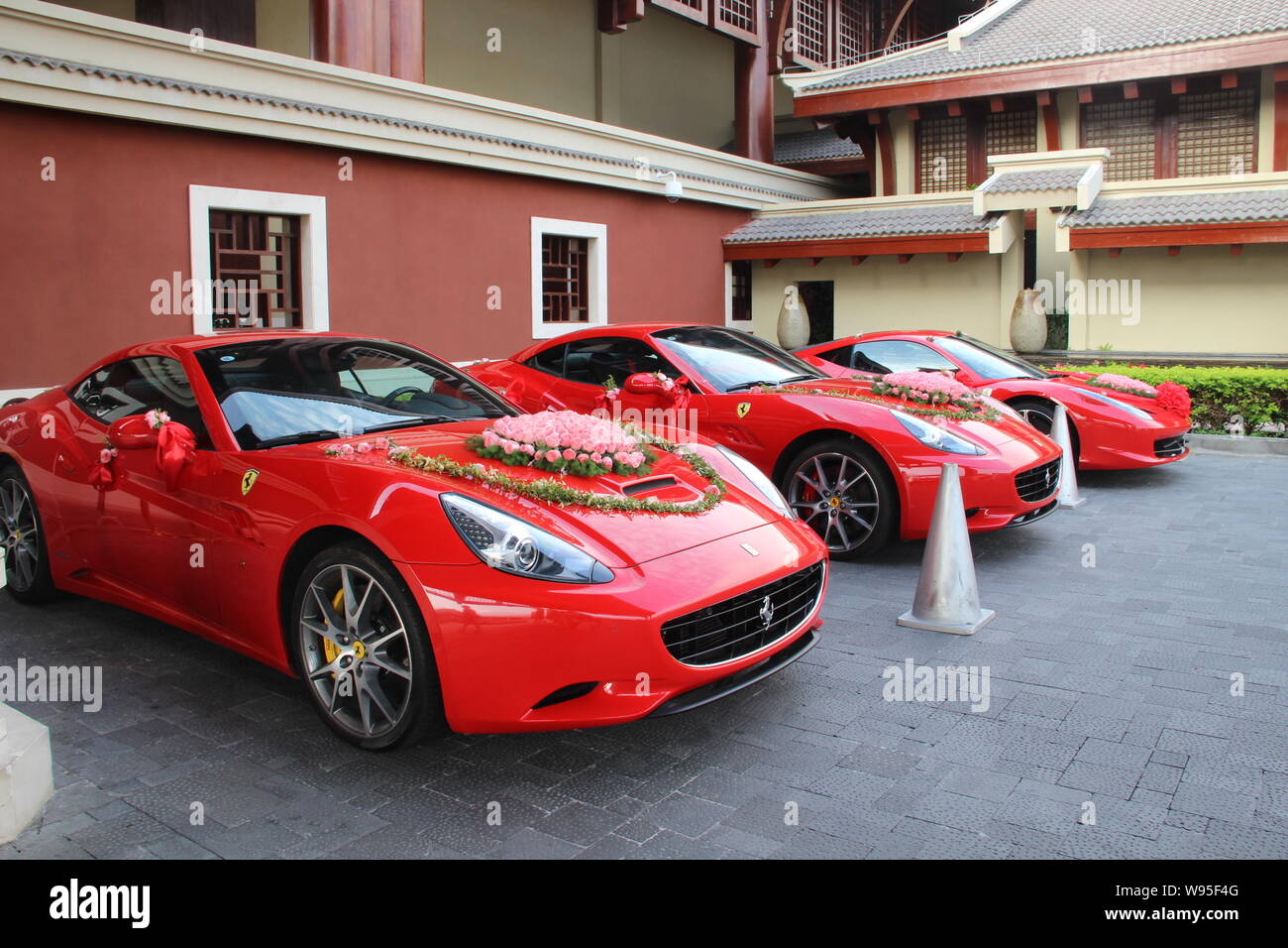 --File--Ferrari sports cars, the brides dowry, park at the hotel where ...