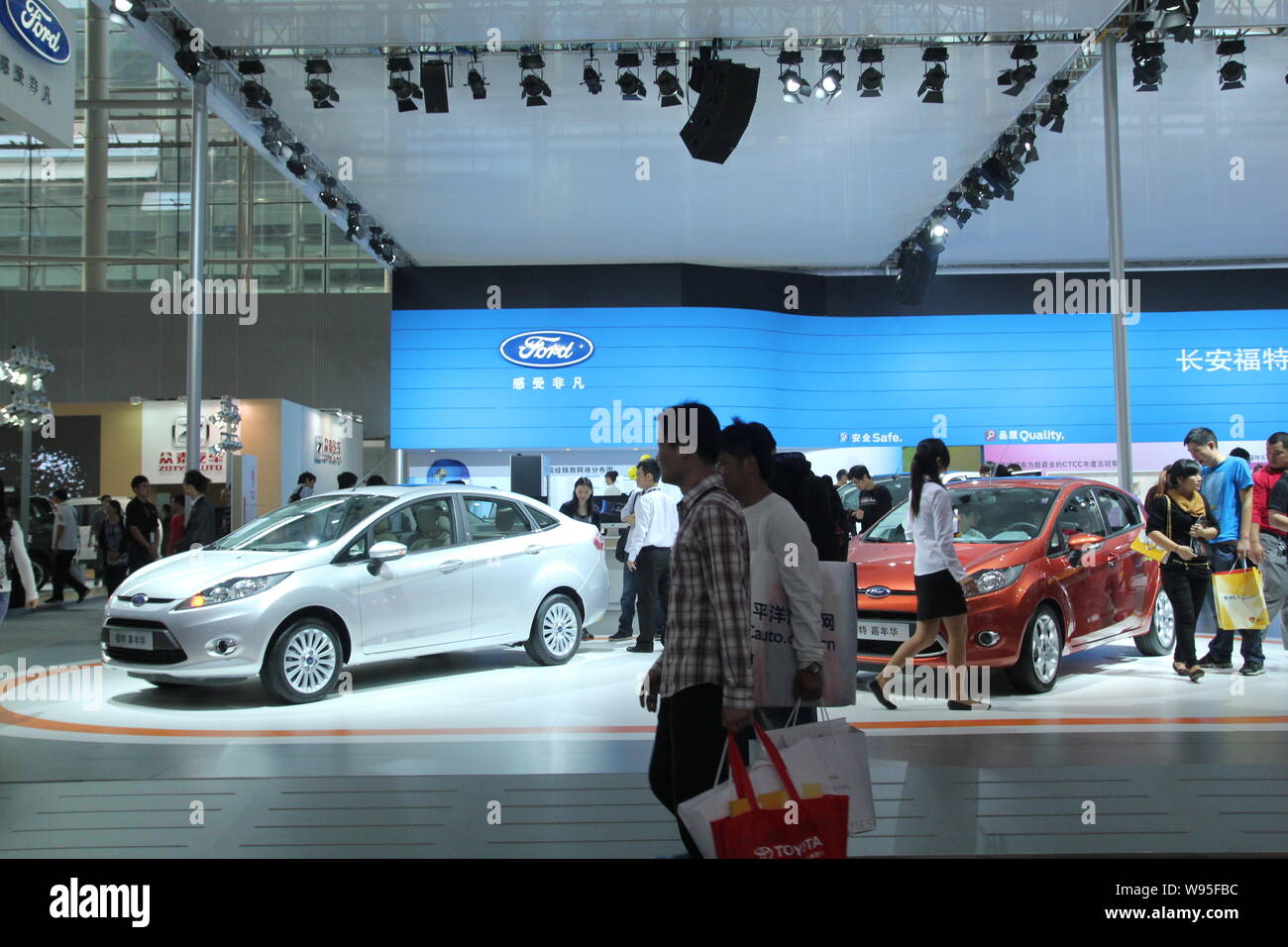 --File--Visitors are seen at the stand of Ford during an auto show in ...