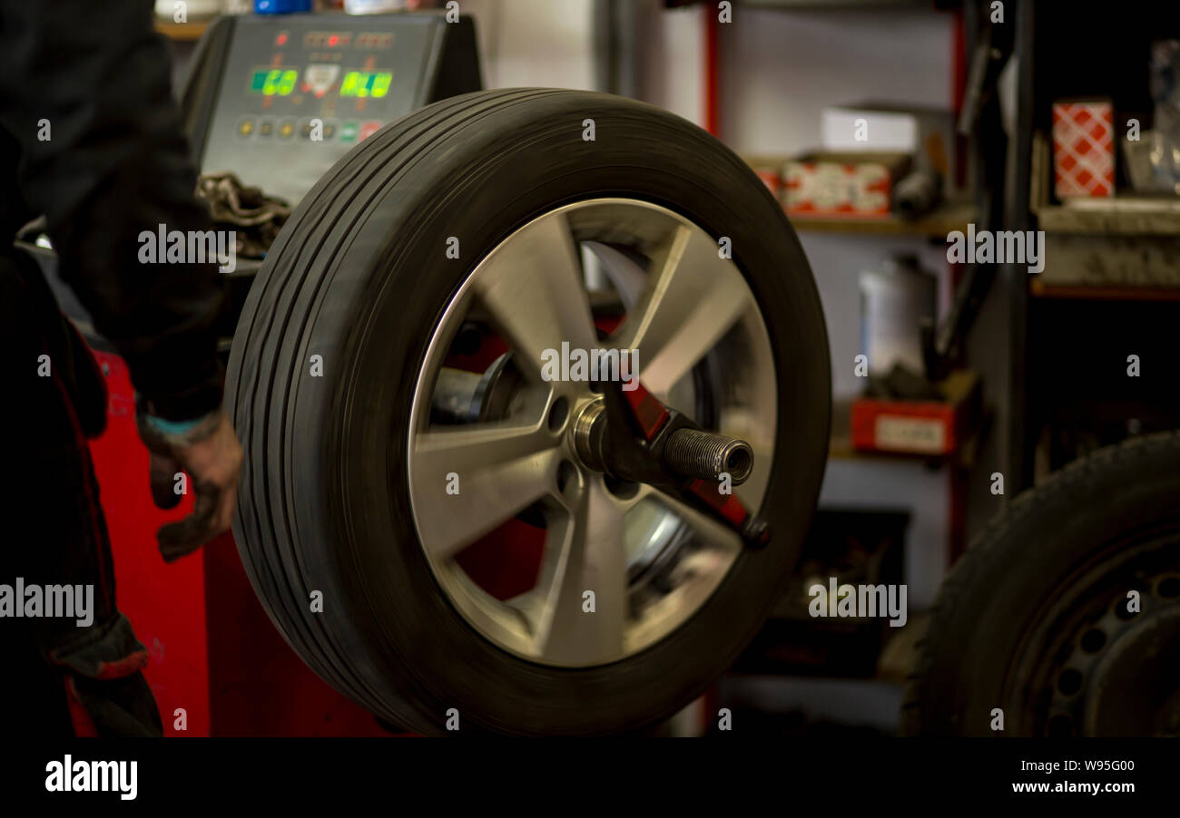 Car tires being changed in garage because of winter season. Workplace ...