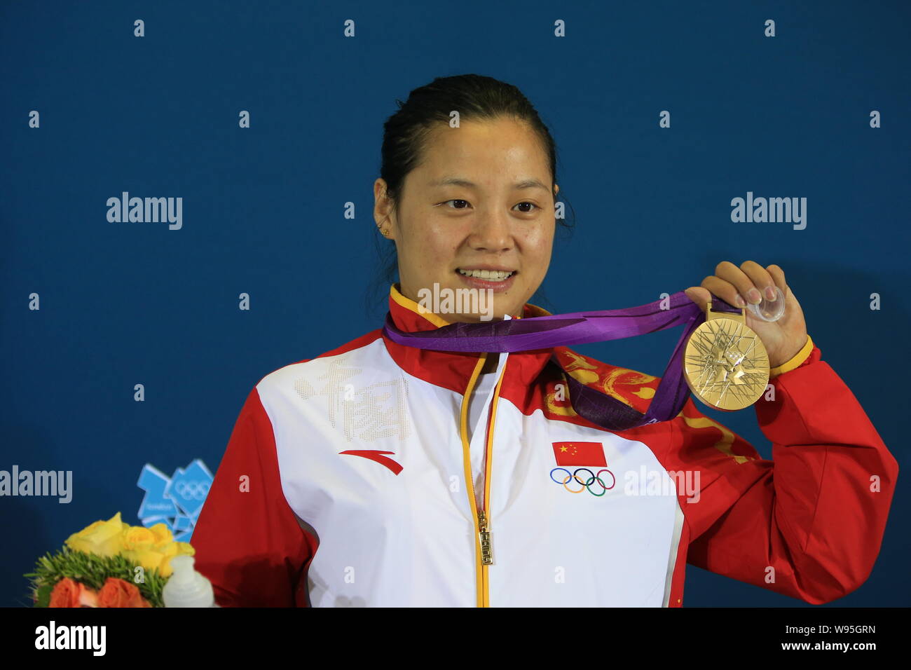 Gold medalist Li Yueying of China shows her medal at a press conference ...