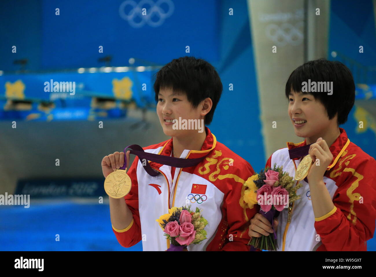 Gold medalists Chen Ruolin, left, and Wang Hao of China show their ...