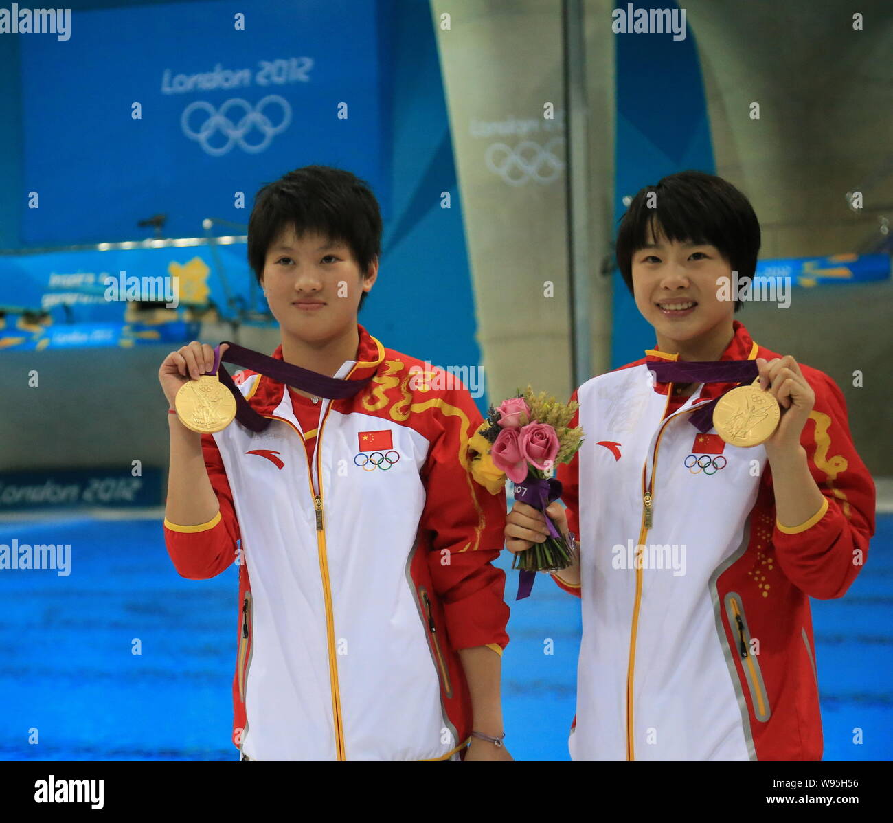 Gold medalists Chen Ruolin, left, and Wang Hao of China show their ...