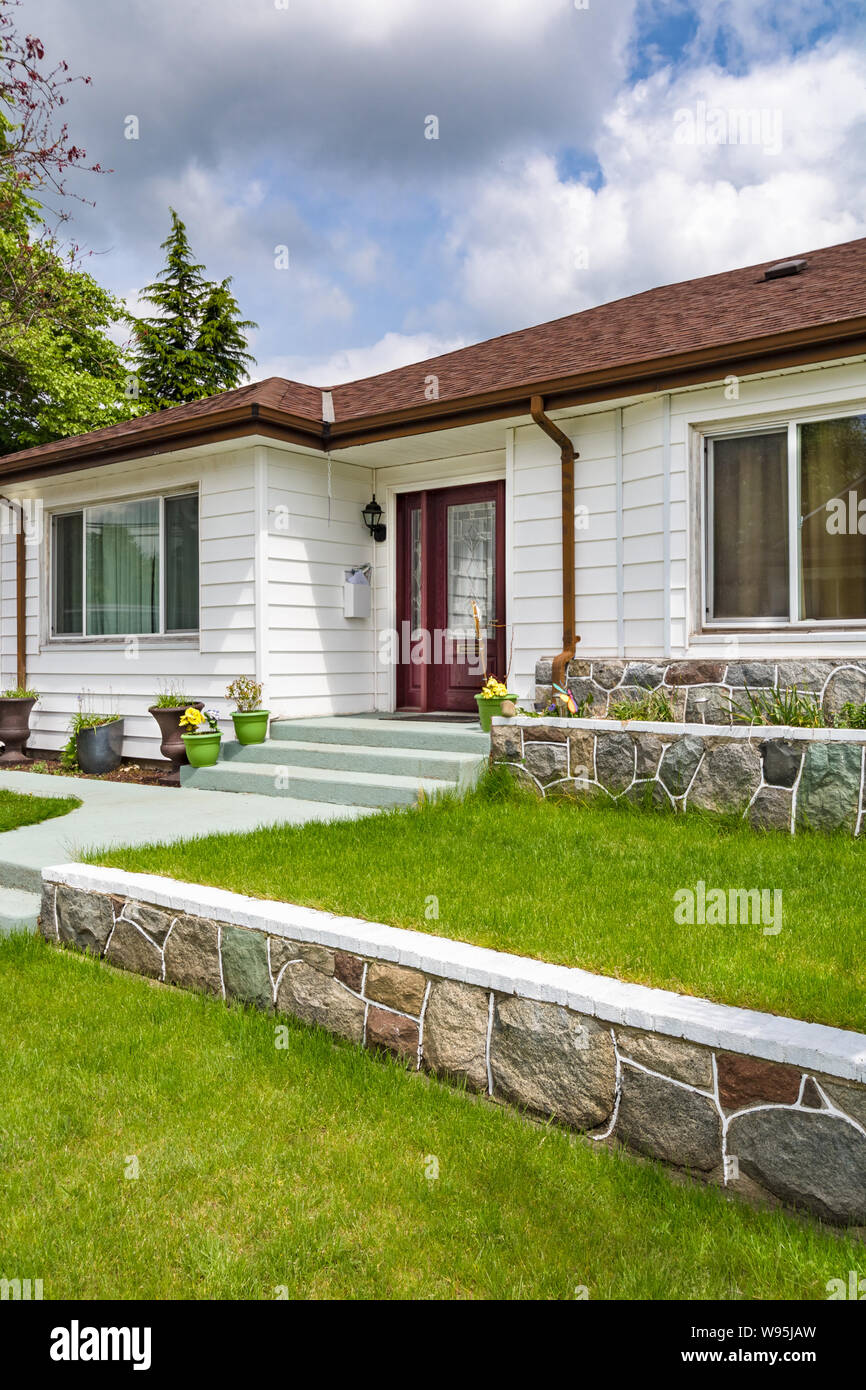 Average residential house with green lawn on land terraces Stock Photo ...