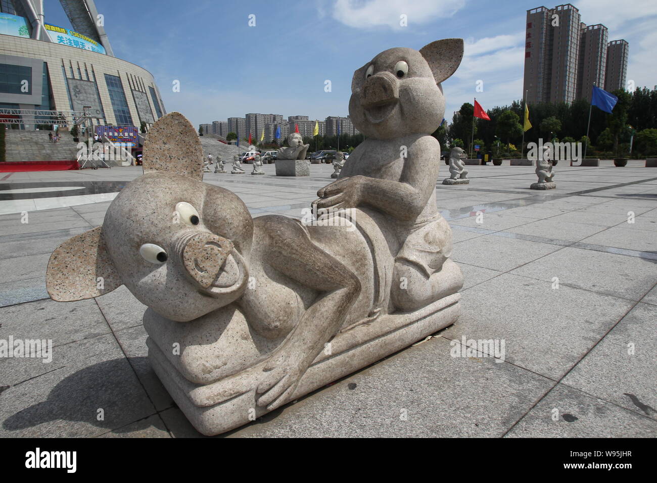 A stone sculpture of two pigs which look like be mating is displayed on ...
