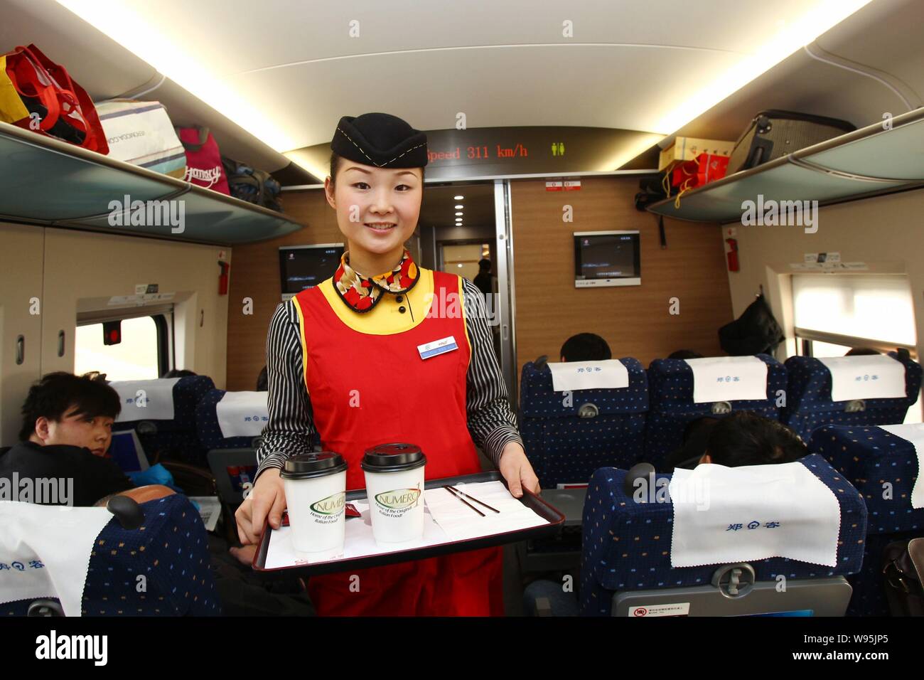 A crew member of CRH (China Railway High-speed) bullet train services ...
