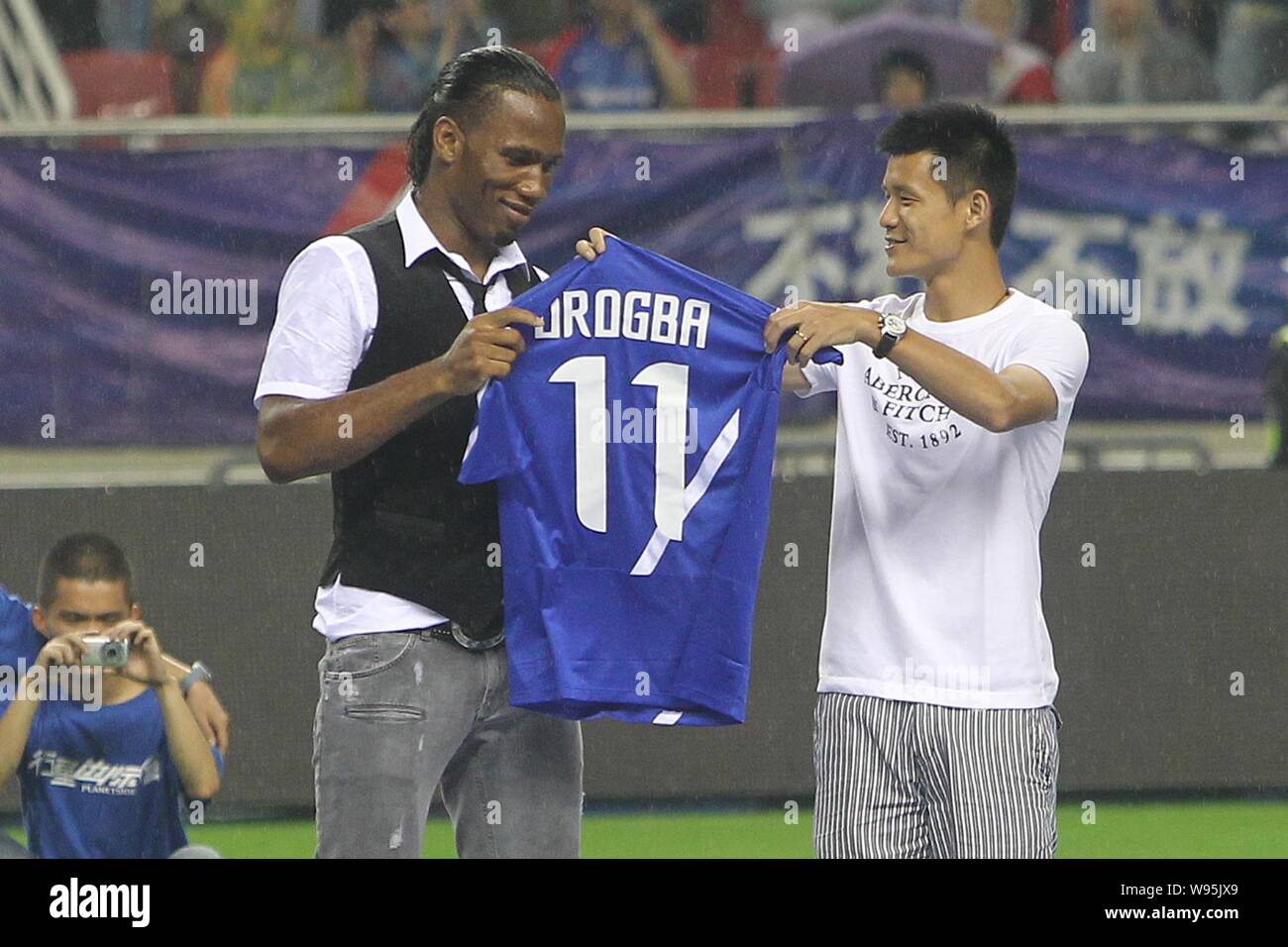Former Chelsea striker Didier Drogba, the new member of Shanghai Shenhua, is presented with his ...