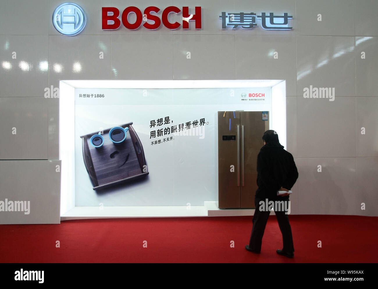 --File--A visitor is seen at the stand of Bosch during a fair in ...