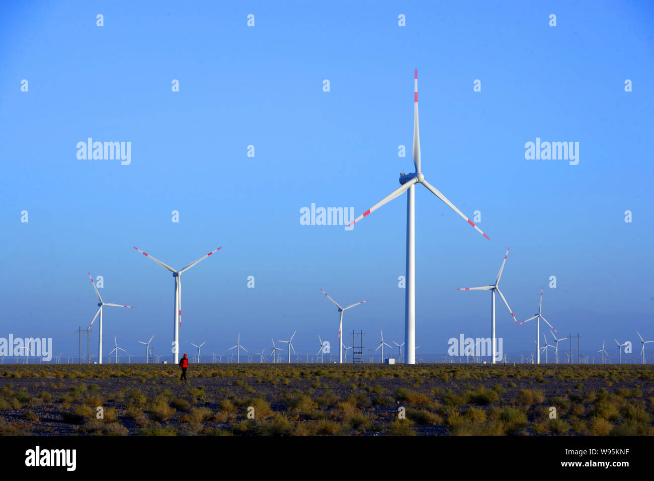 --FILE--Wind turbines whirl to generate electricity at a wind farm in ...