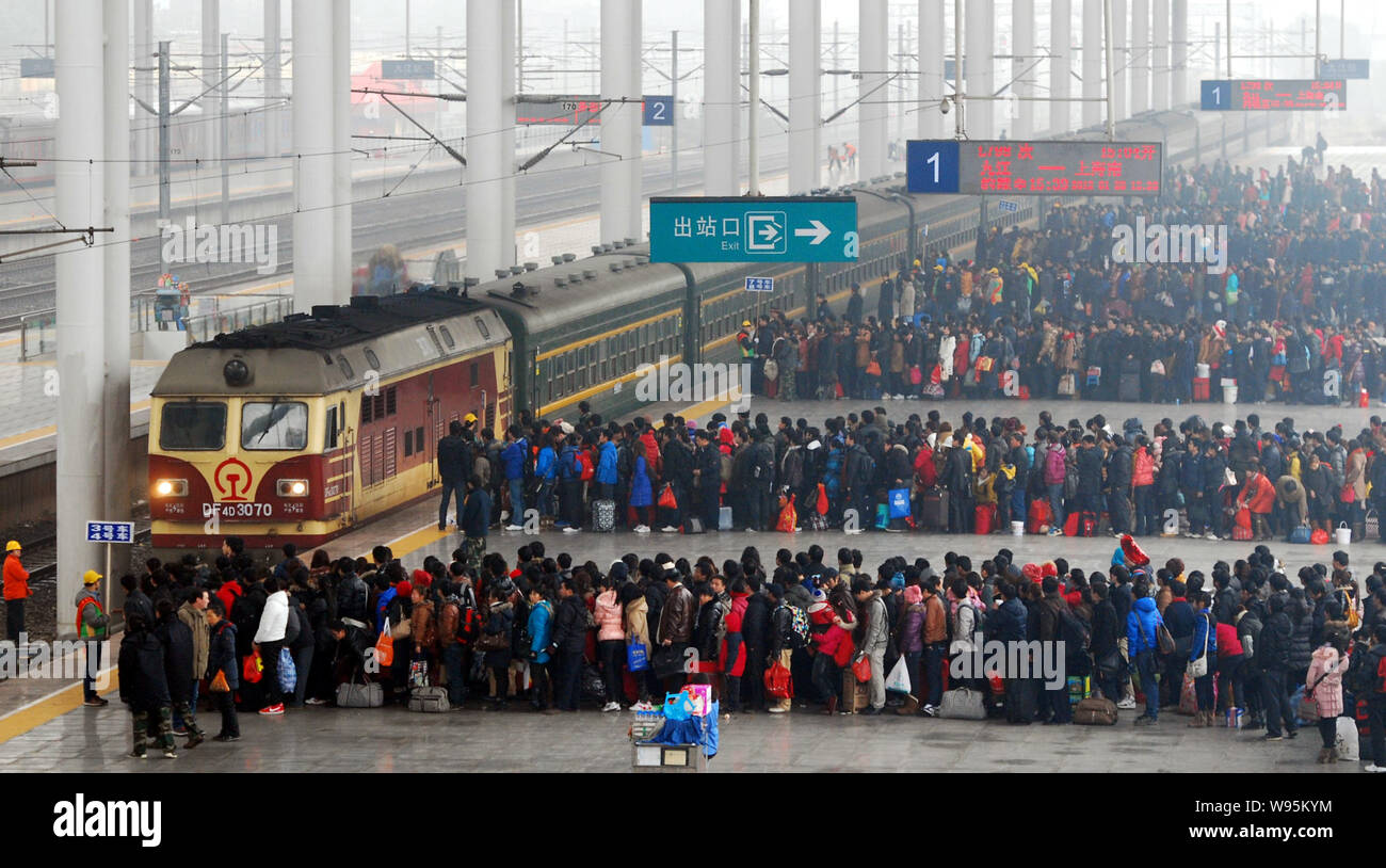 Chinese passengers line up on the platform to wait for a train at the ...