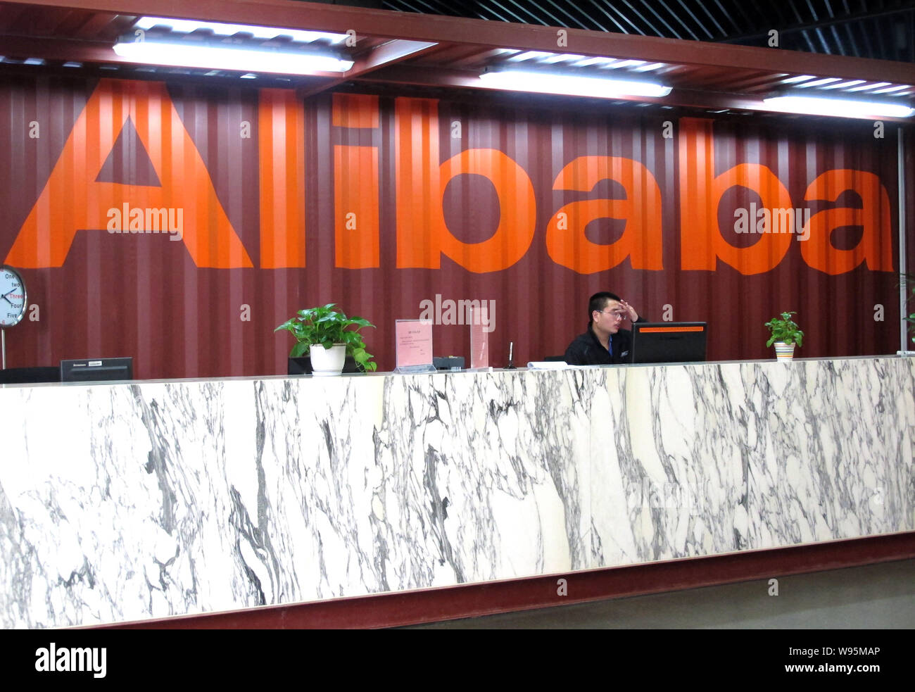 --File--A Chinese staff is seen at the reception desk at the Shanghai ...