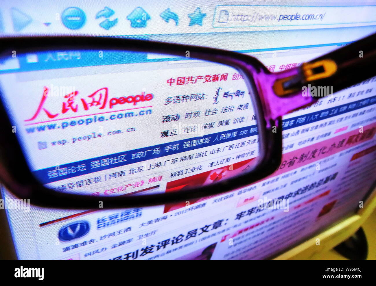 --File--A netizen browses Peoples Daily Online, a website built by ...