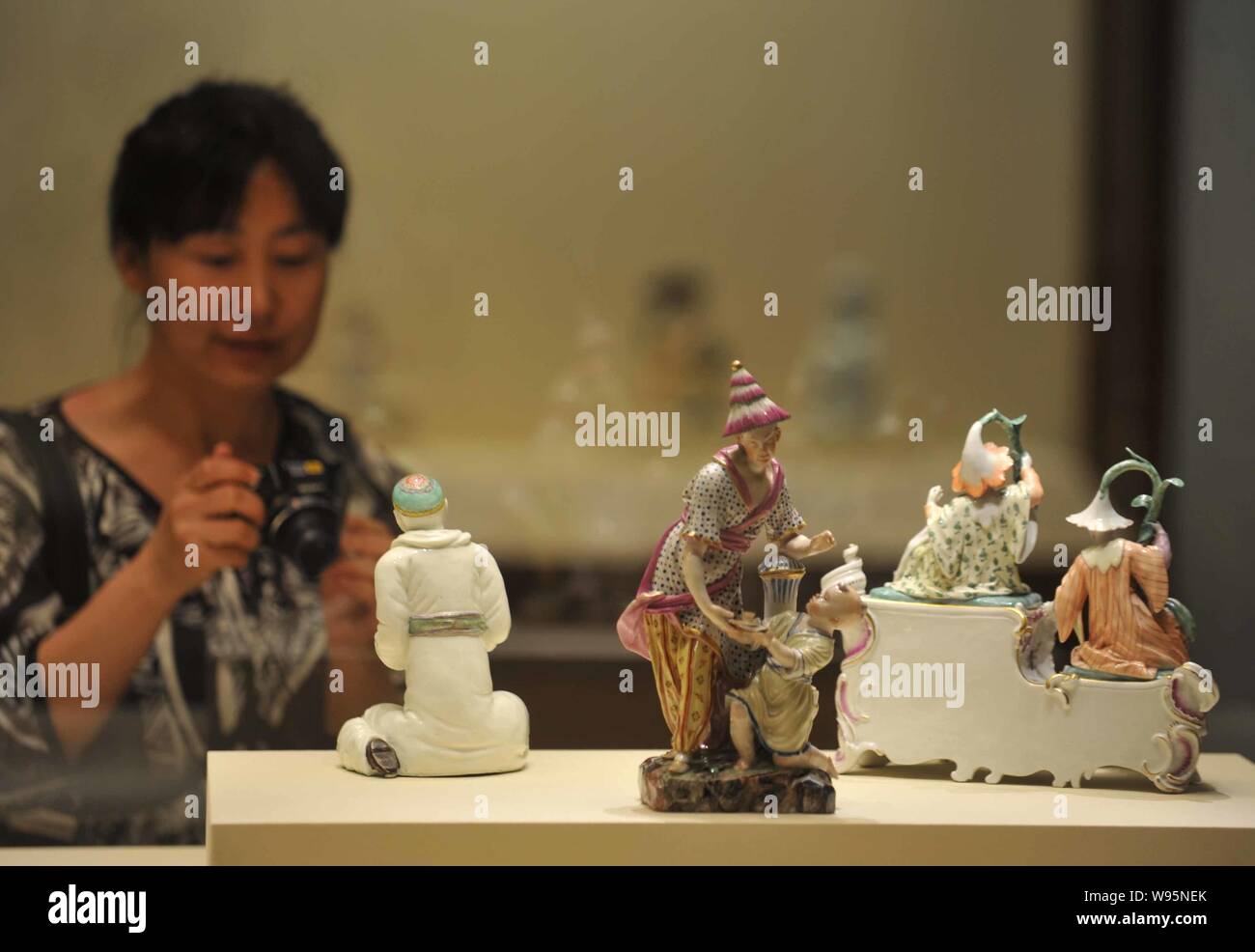 A visitor takes pictures of a porcelain masterpiece set at the Passion ...
