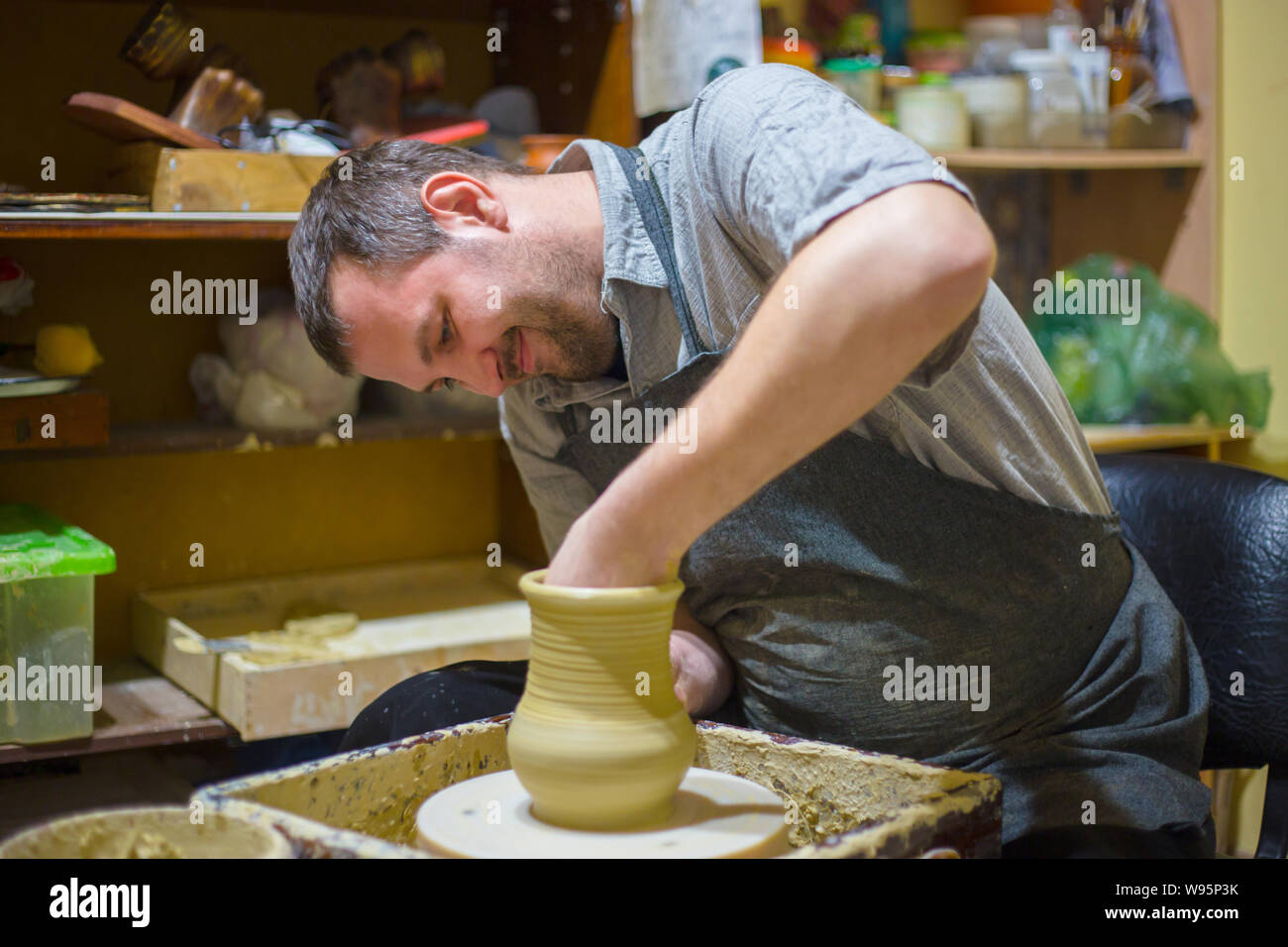 Professional male potter making jug in pottery workshop Stock Photo - Alamy