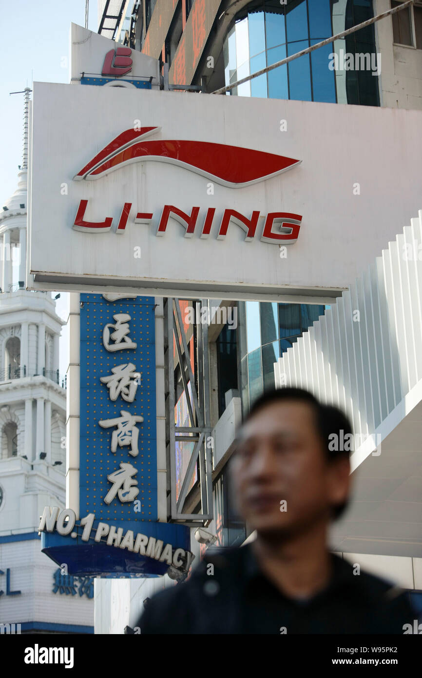 A pedestrian walks past a Li-Ning sportswear store in Shanghai, China ...